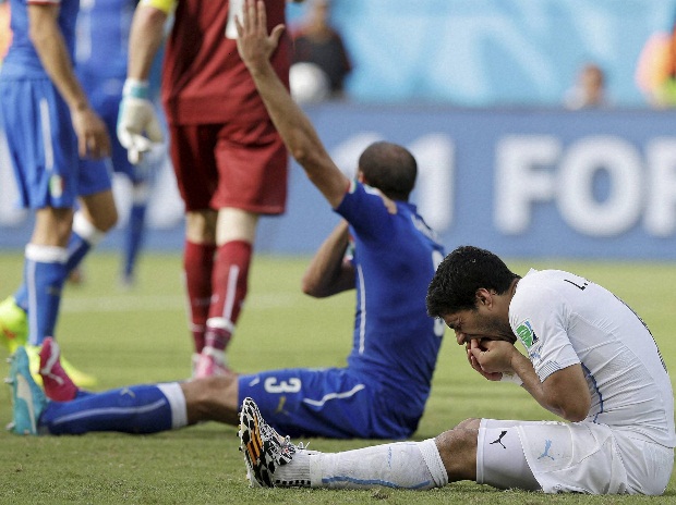 Suarez banned for nine matches and four months over biting incident