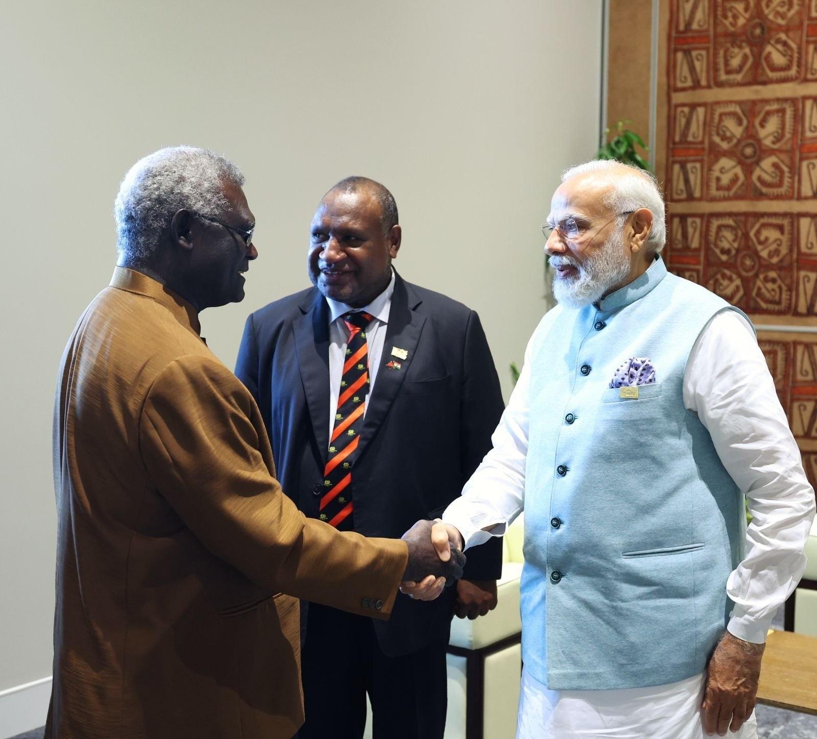 As a mark of respect, Papua New Guinea PM touches PM Modi's feet; see ...